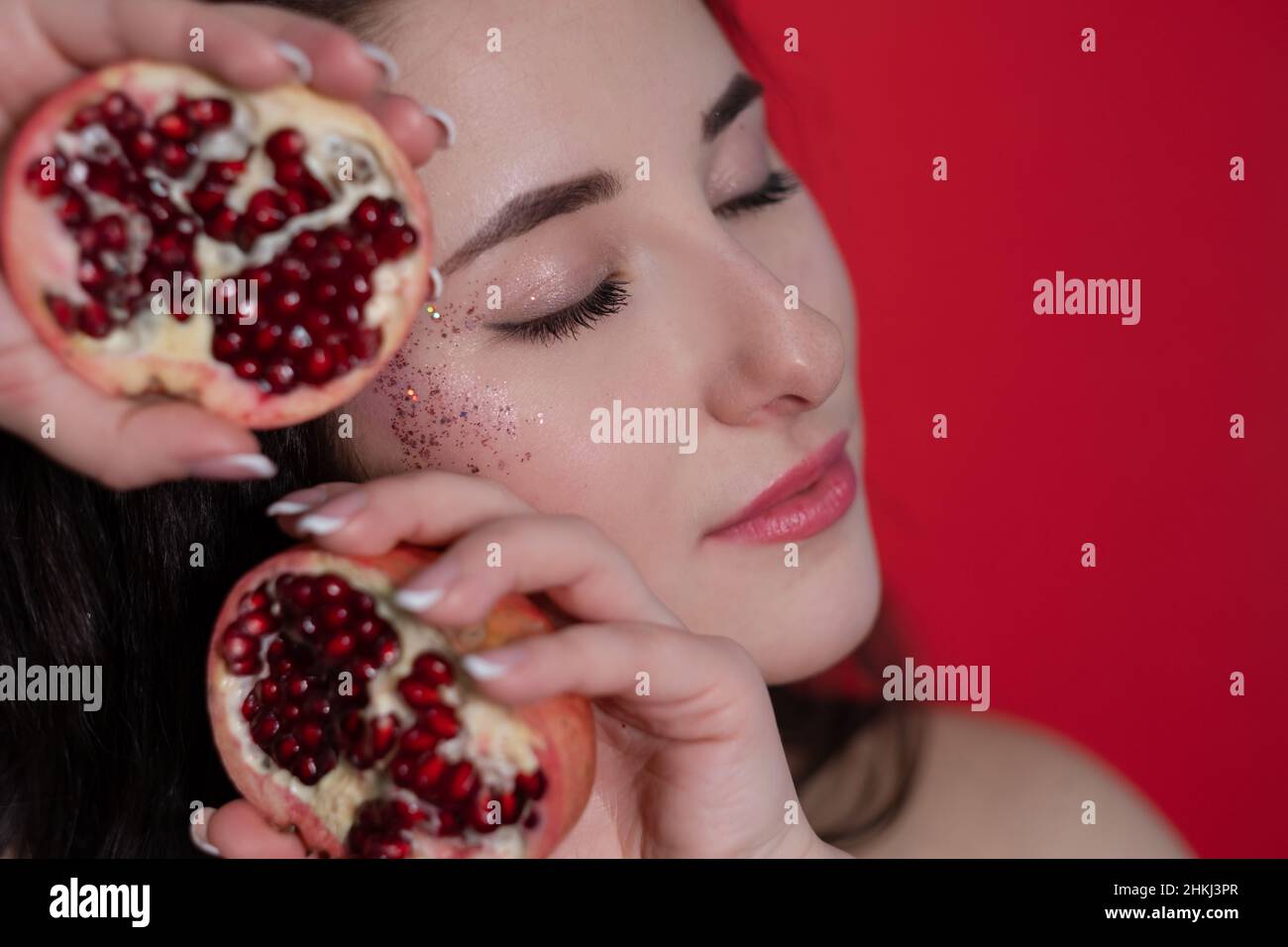 charming brunette woman girl female with cropped half pomegranate near ...