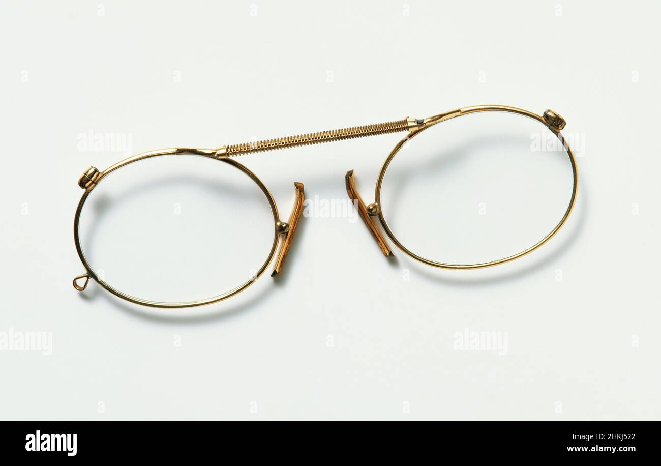 Old wire glasses frame with arms missing Stock Photo - Alamy