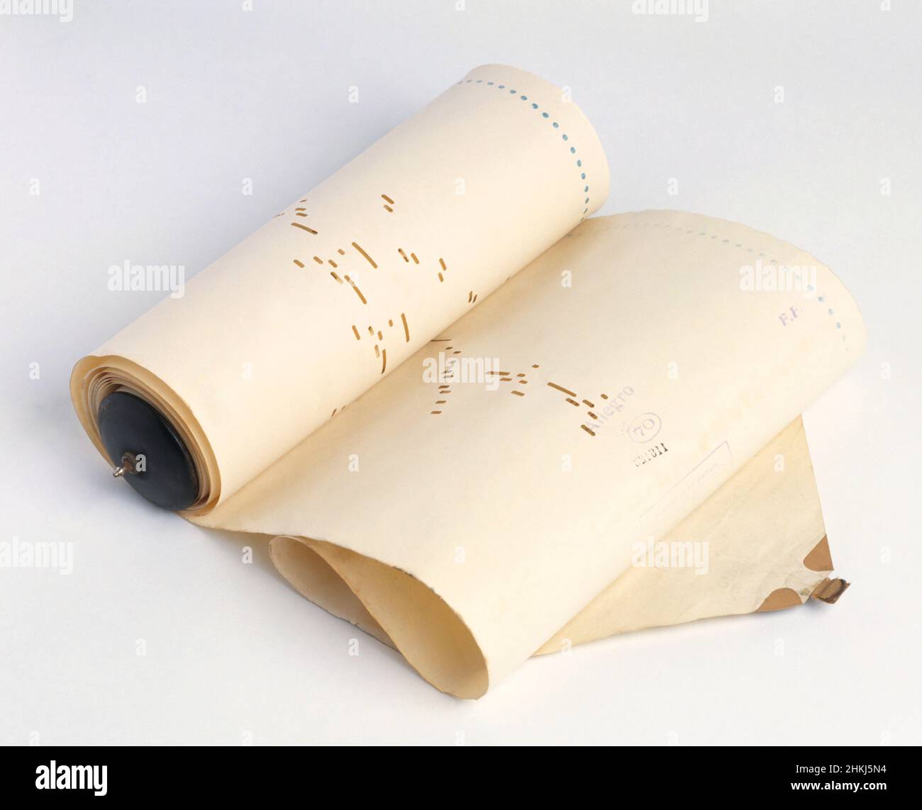 Music roll showing pattern of holes representing notes Stock Photo - Alamy
