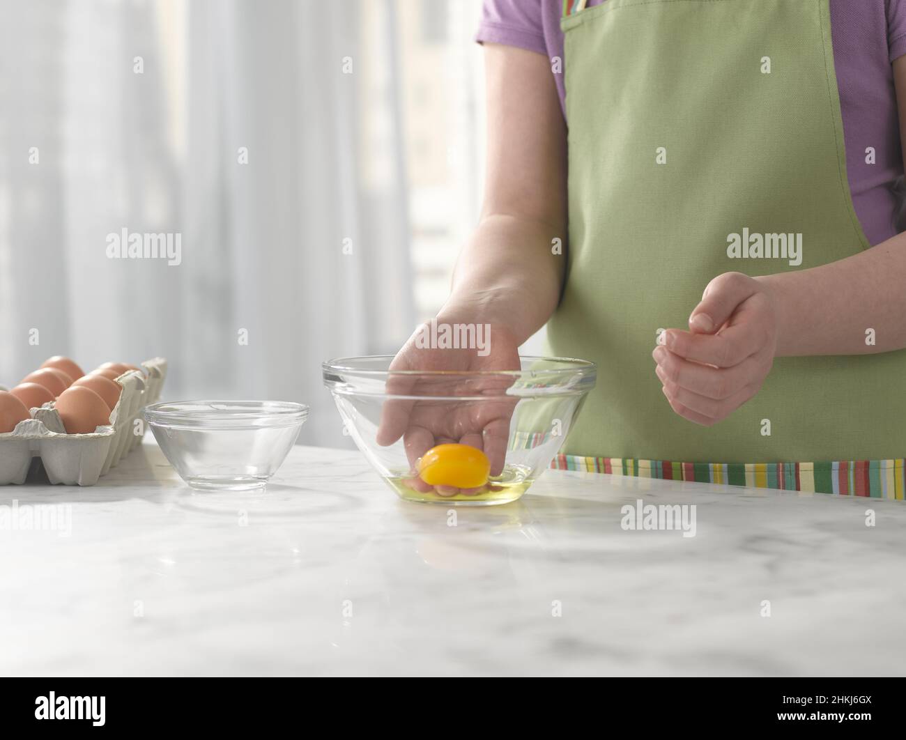 Child scooping up egg yoke in hand Stock Photo - Alamy