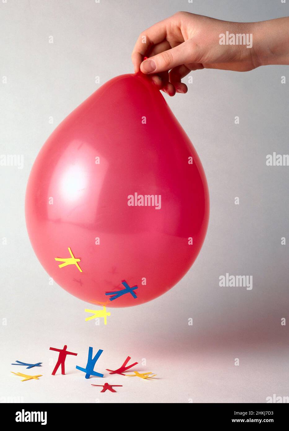 Hand holding red balloon with stickmen cut-outs attached Stock Photo ...