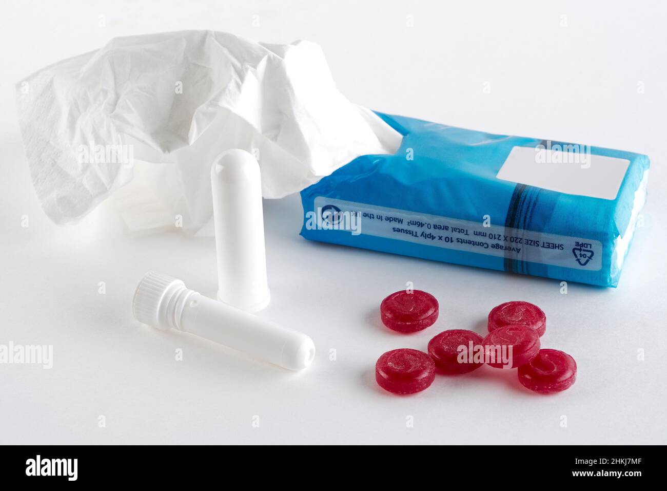 Tissues, red menthol lozenges and menthol inhaler Stock Photo - Alamy