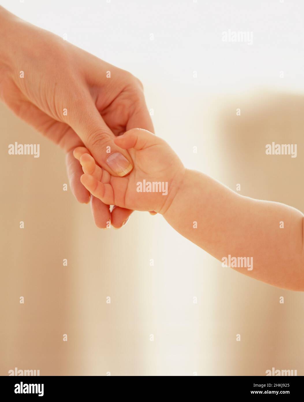 Hand pressing into a baby hand Stock Photo - Alamy