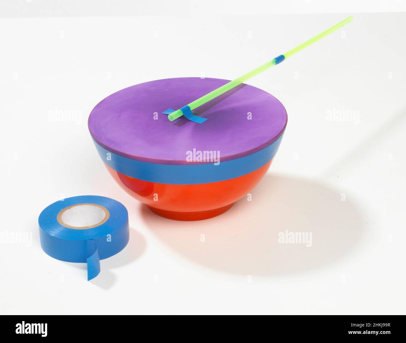 Balloon stretched over bowl with straw taped to it Stock Photo - Alamy