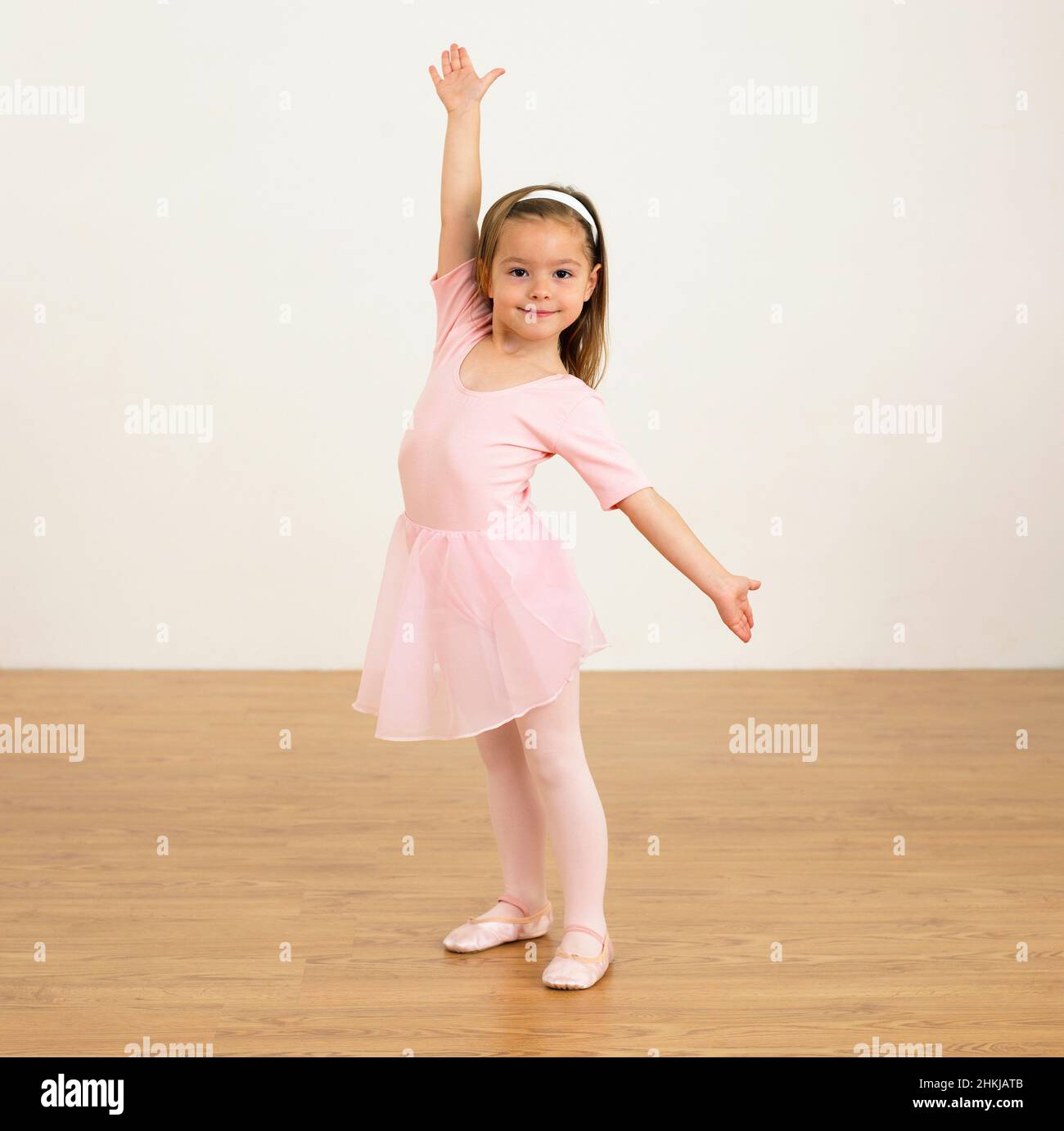 Girl in ballerina outfit holding one arm up Stock Photo - Alamy