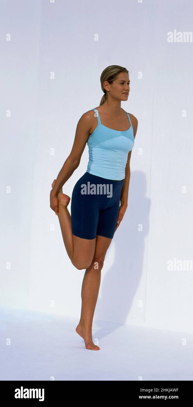 Woman standing on one leg Stock Photo - Alamy