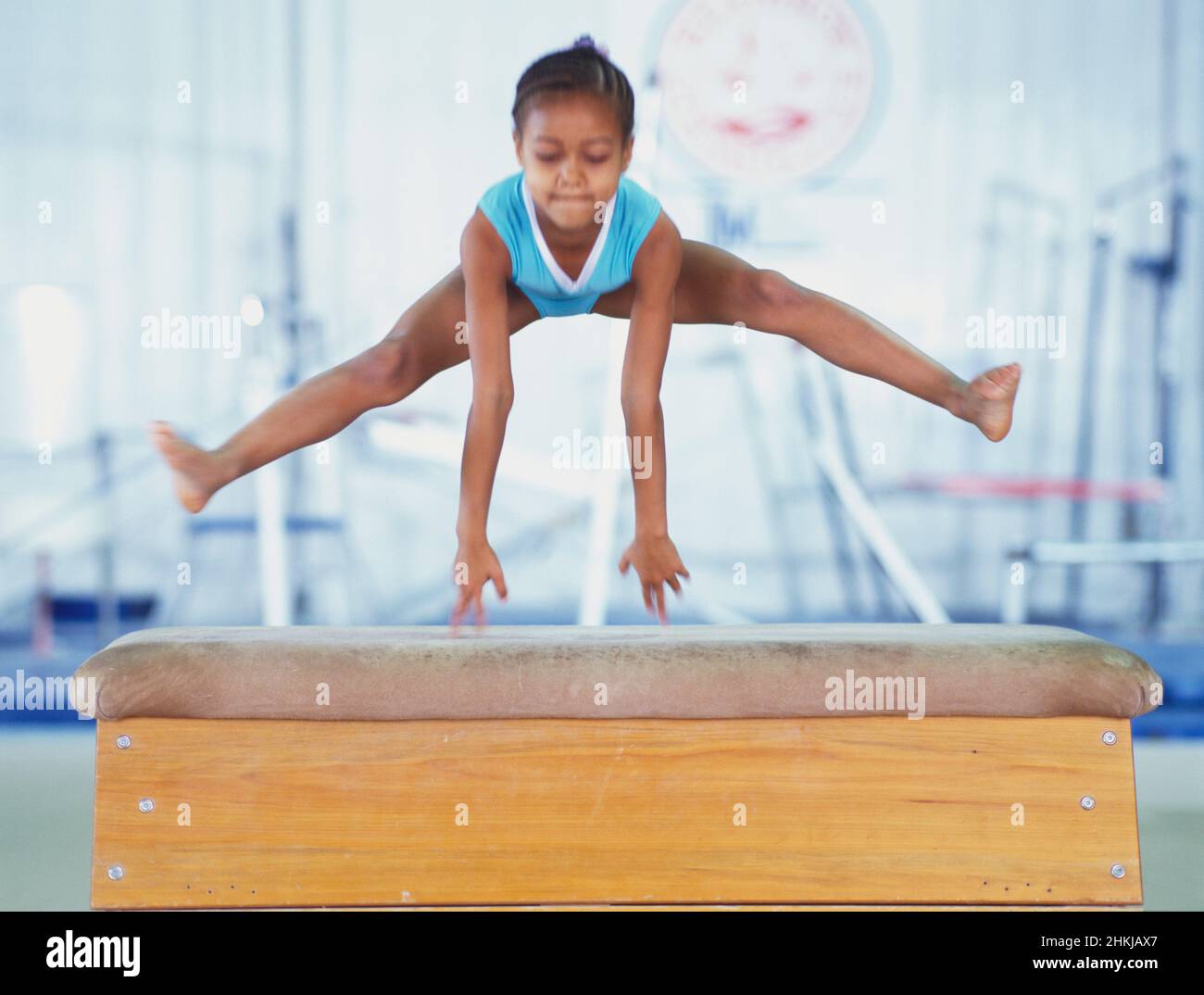Girl jumping across vault Stock Photo - Alamy