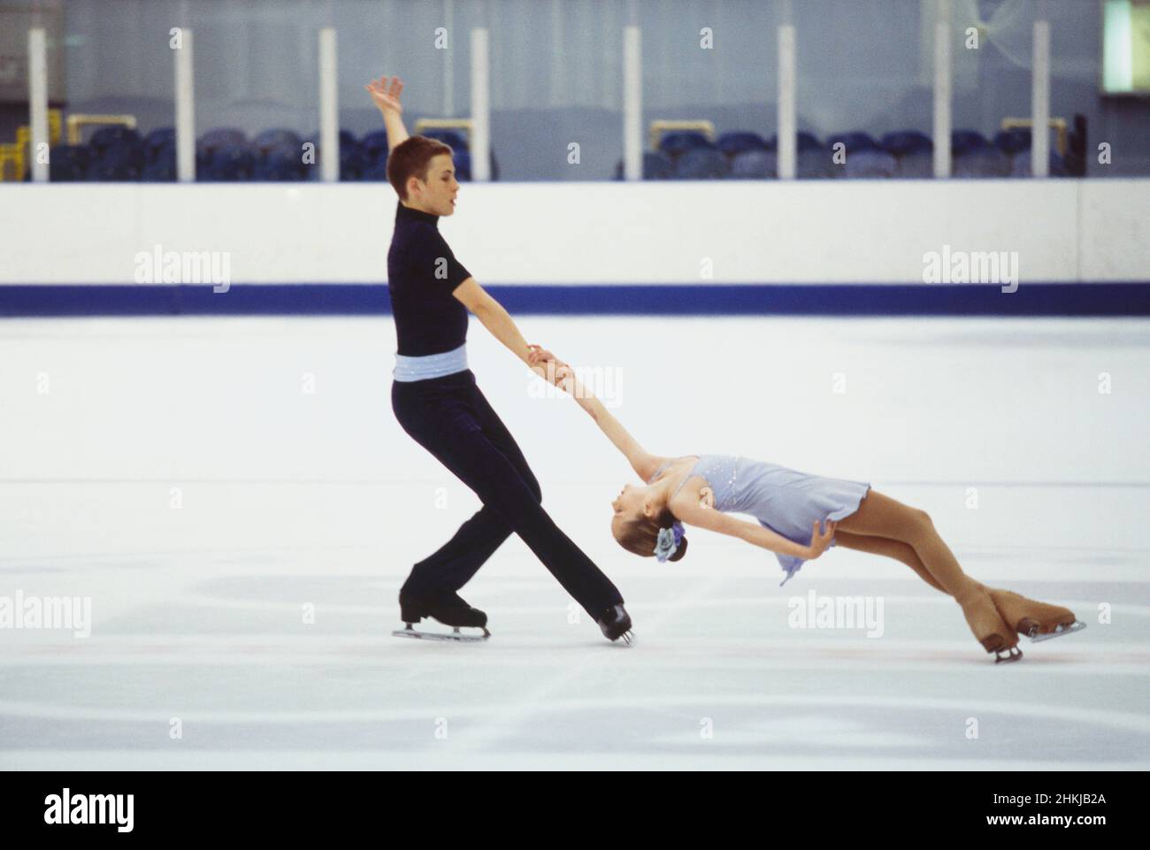 Ice skating couple performing death spiral Stock Photo - Alamy