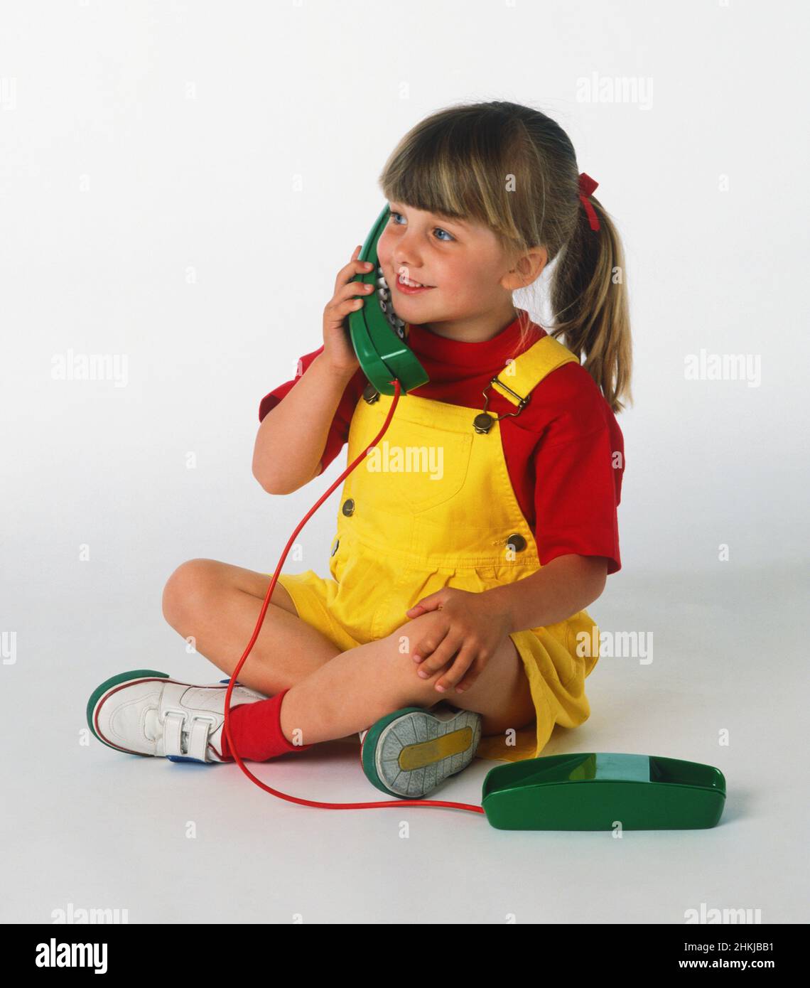 Young girl talking on a telephone Stock Photo - Alamy