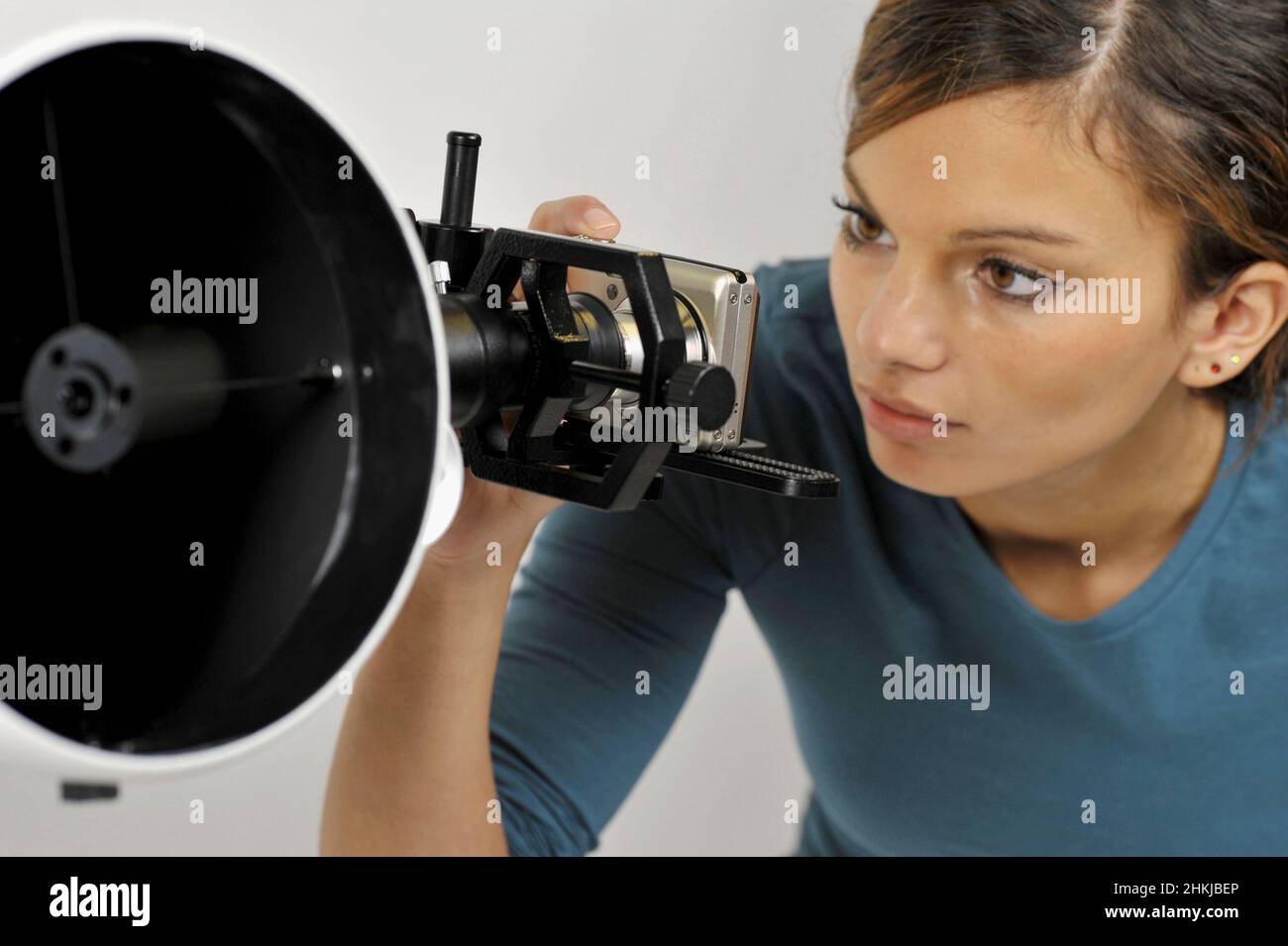 Woman using camera to take photos through telescope lens Stock Photo ...