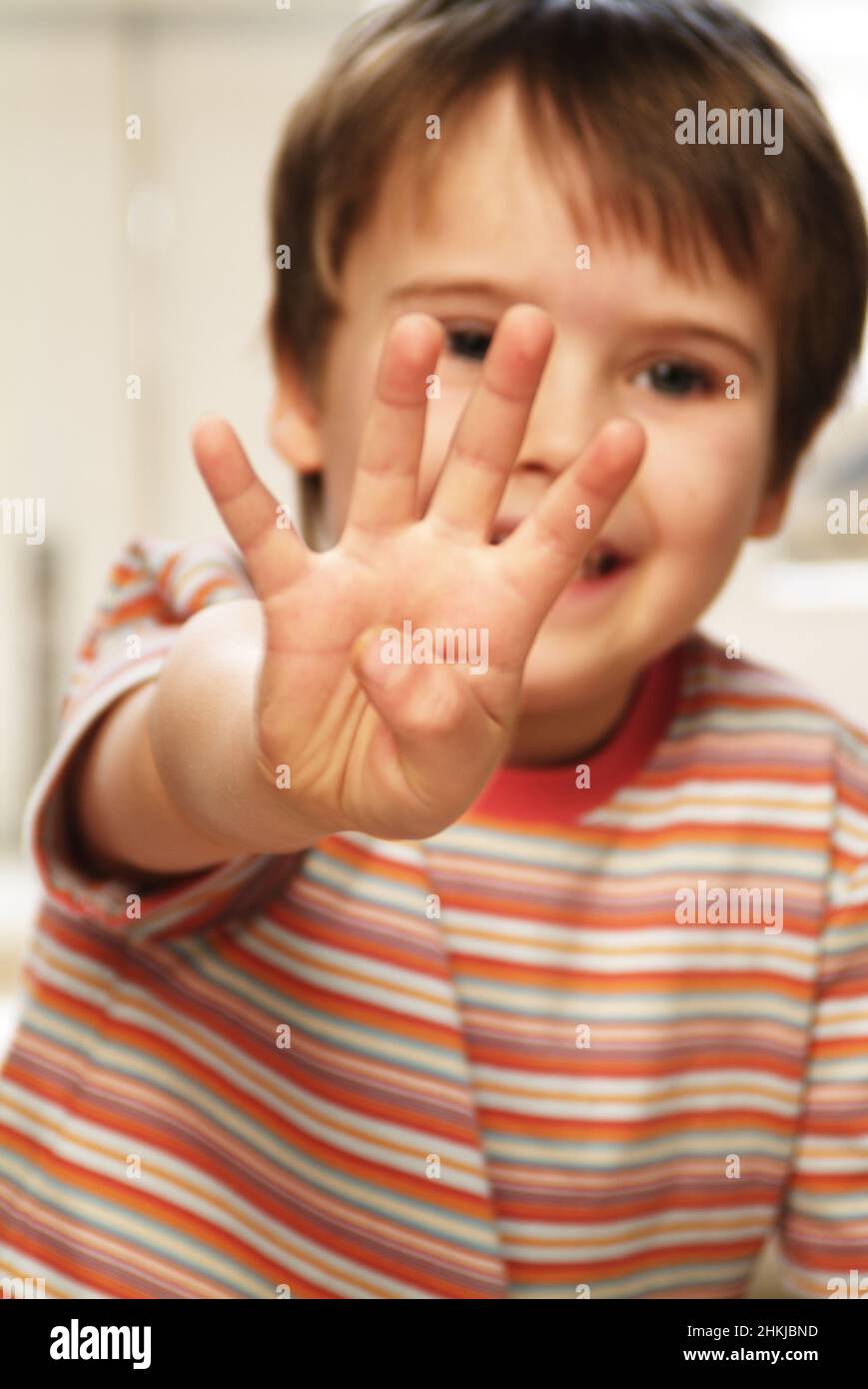 Boy holding four fingers up Stock Photo - Alamy