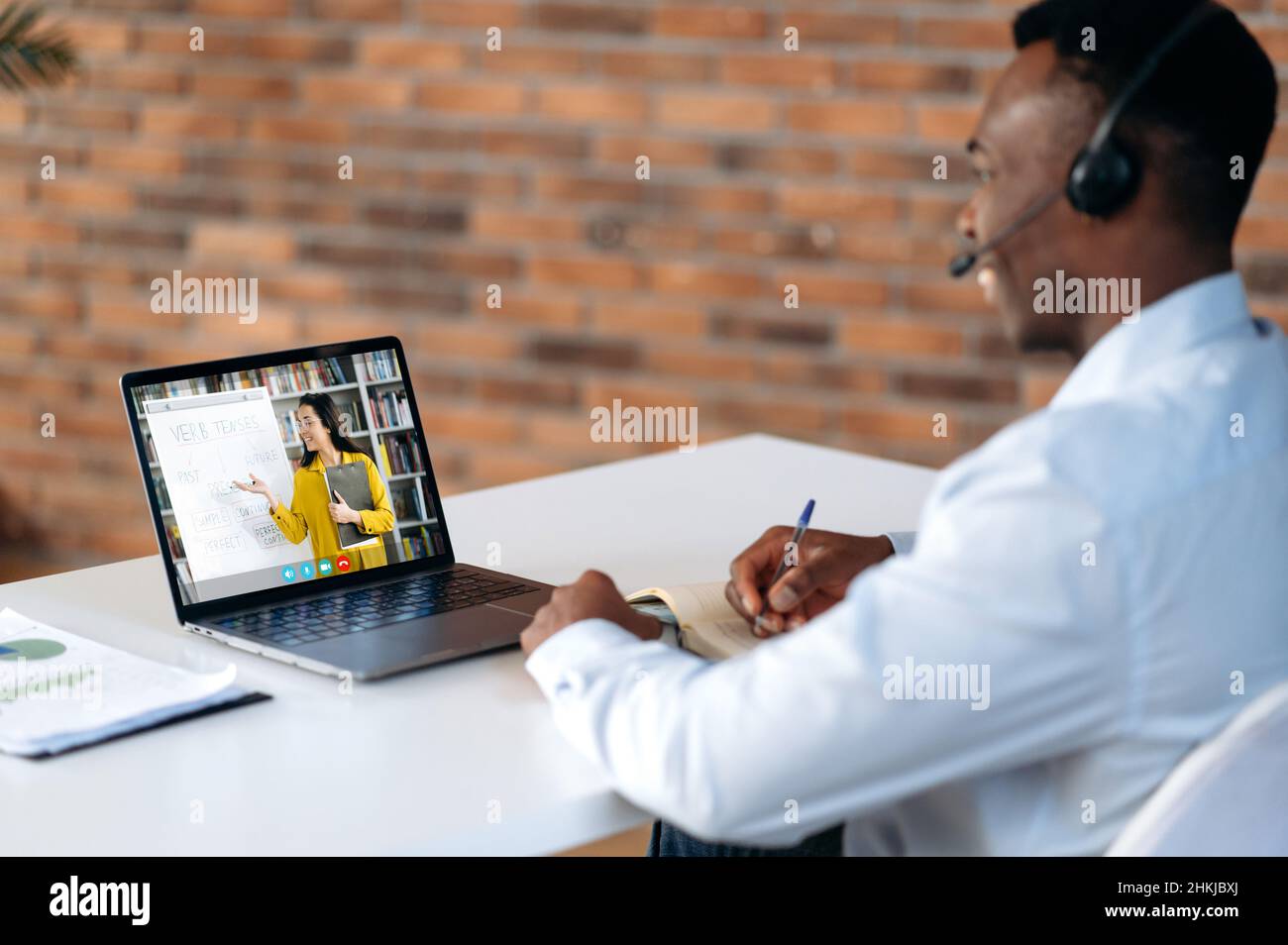 E-learning. Successful smart young african american man, looking at ...