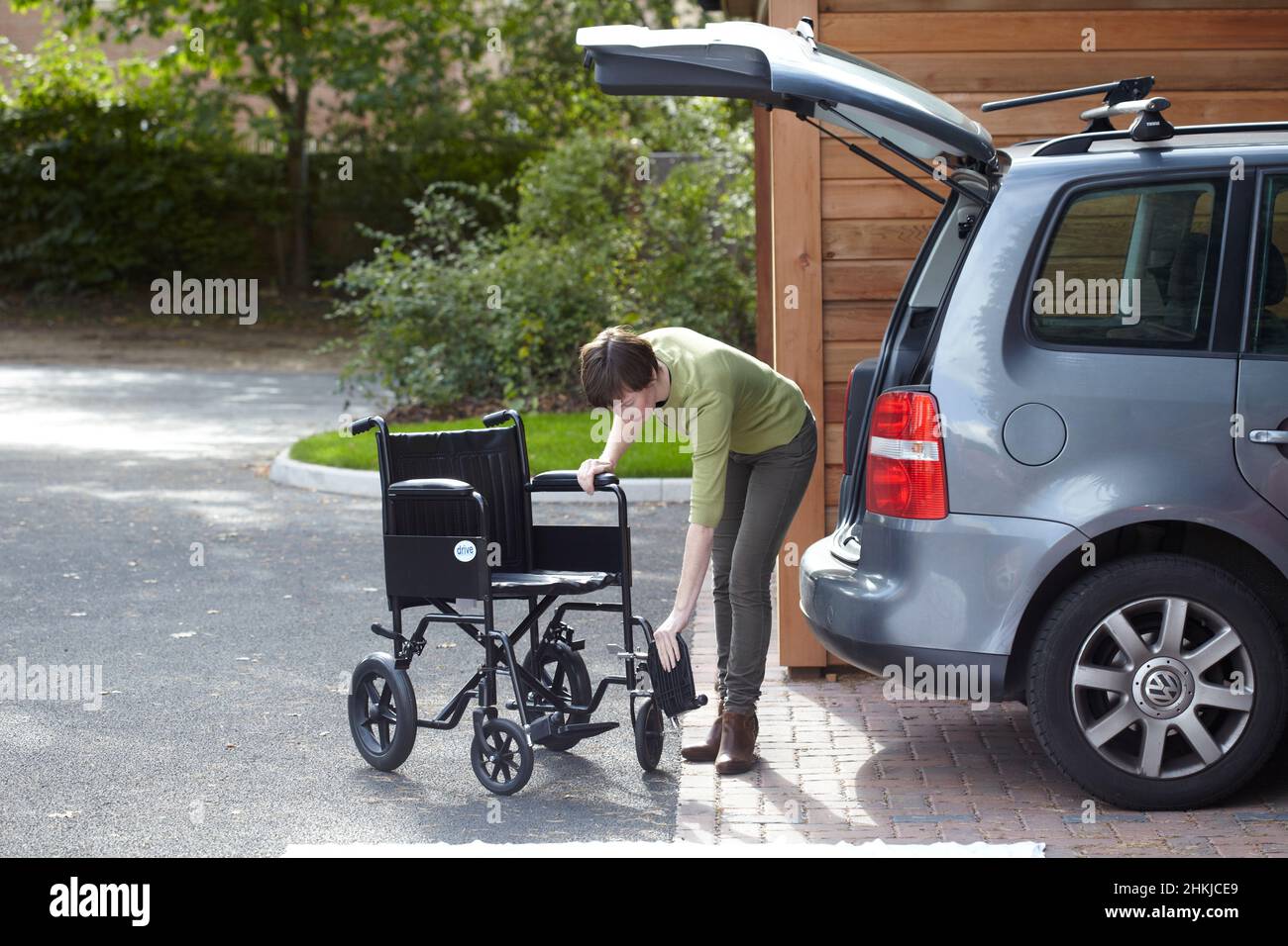 Unfolding a wheelchair Stock Photo - Alamy