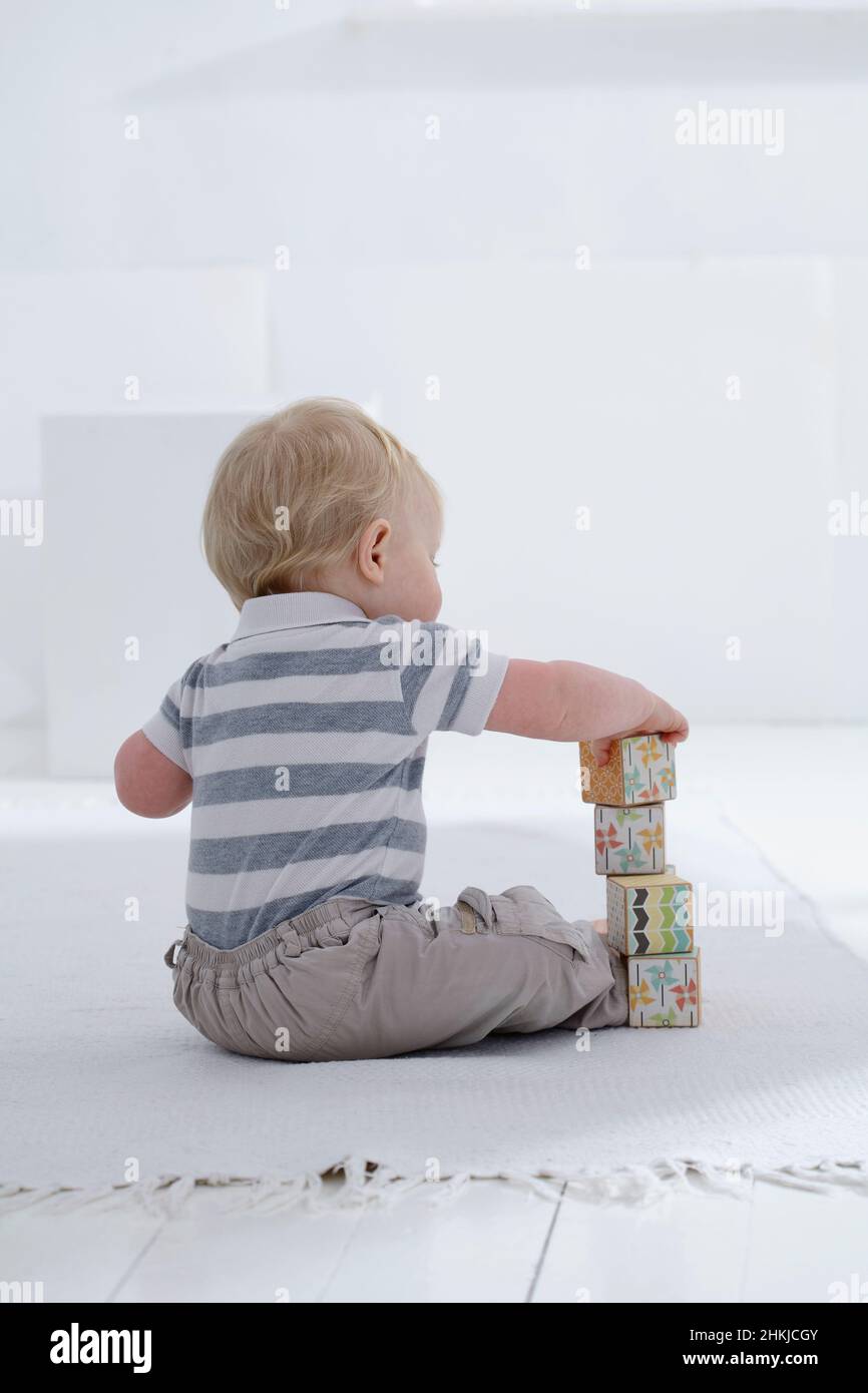 Baby boy stacking decoupage blocks Stock Photo - Alamy