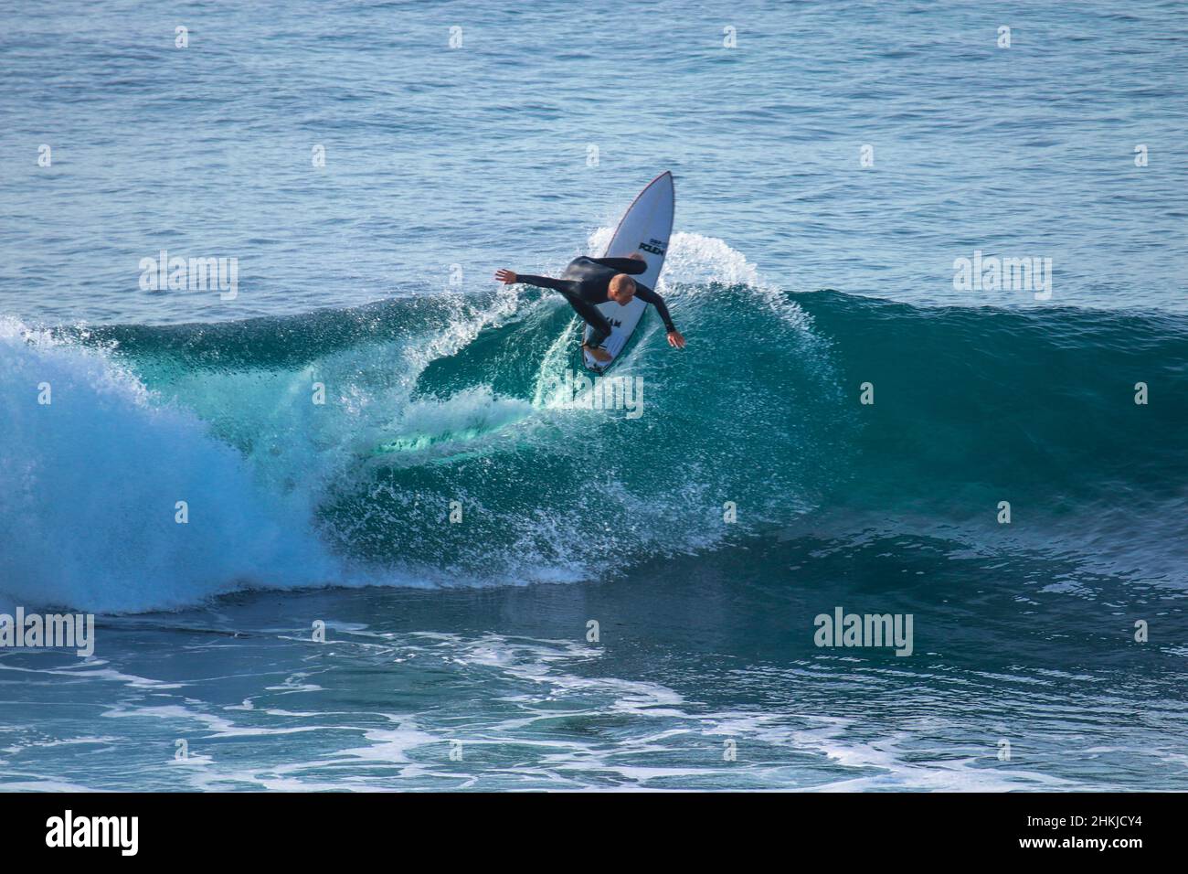 Surfer making a maneuver in a wave Stock Photo - Alamy