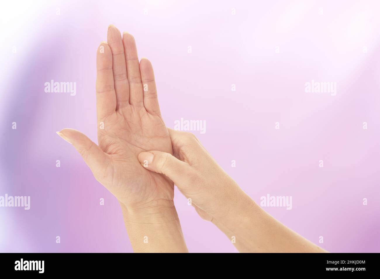 Pressing into palm of hand to ease pain in trunk of body Stock Photo ...