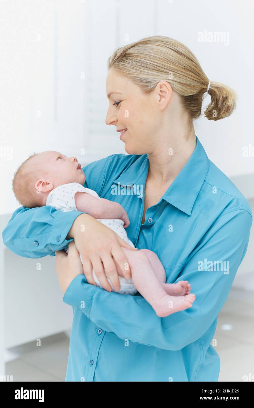 Mother comforting baby girl Stock Photo - Alamy