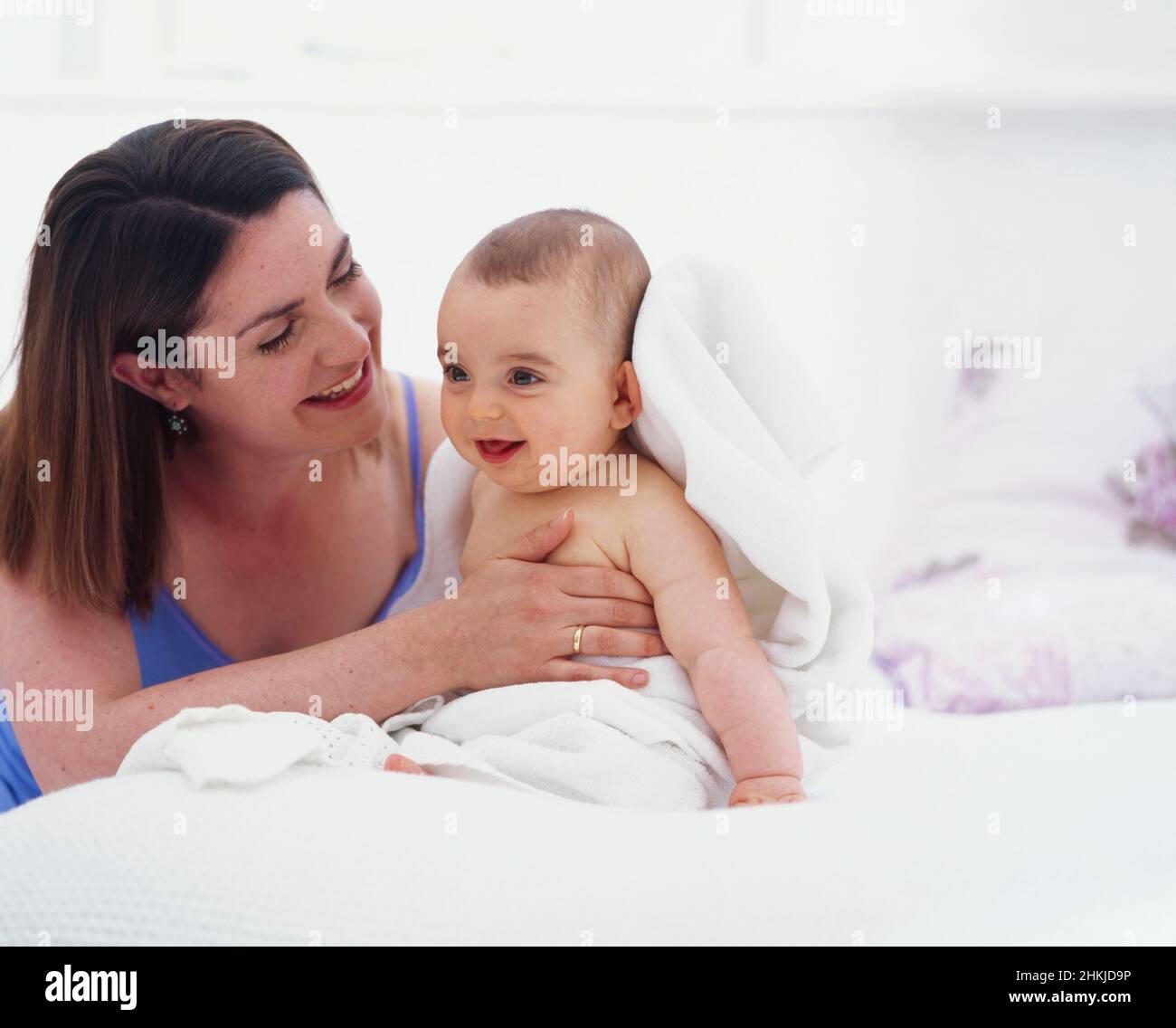 Woman supporting baby boy in upright sitting position Stock Photo - Alamy