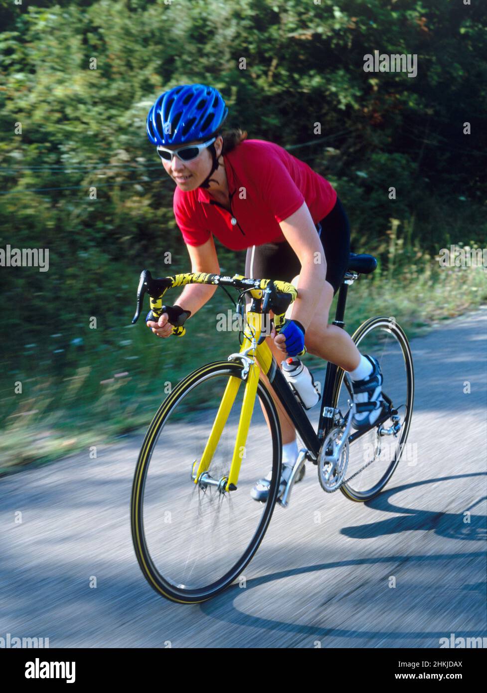 Woman riding racing bike Stock Photo - Alamy