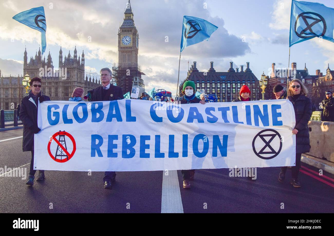 Demonstrators march along Westminster Bridge with a 'Global Coastline ...