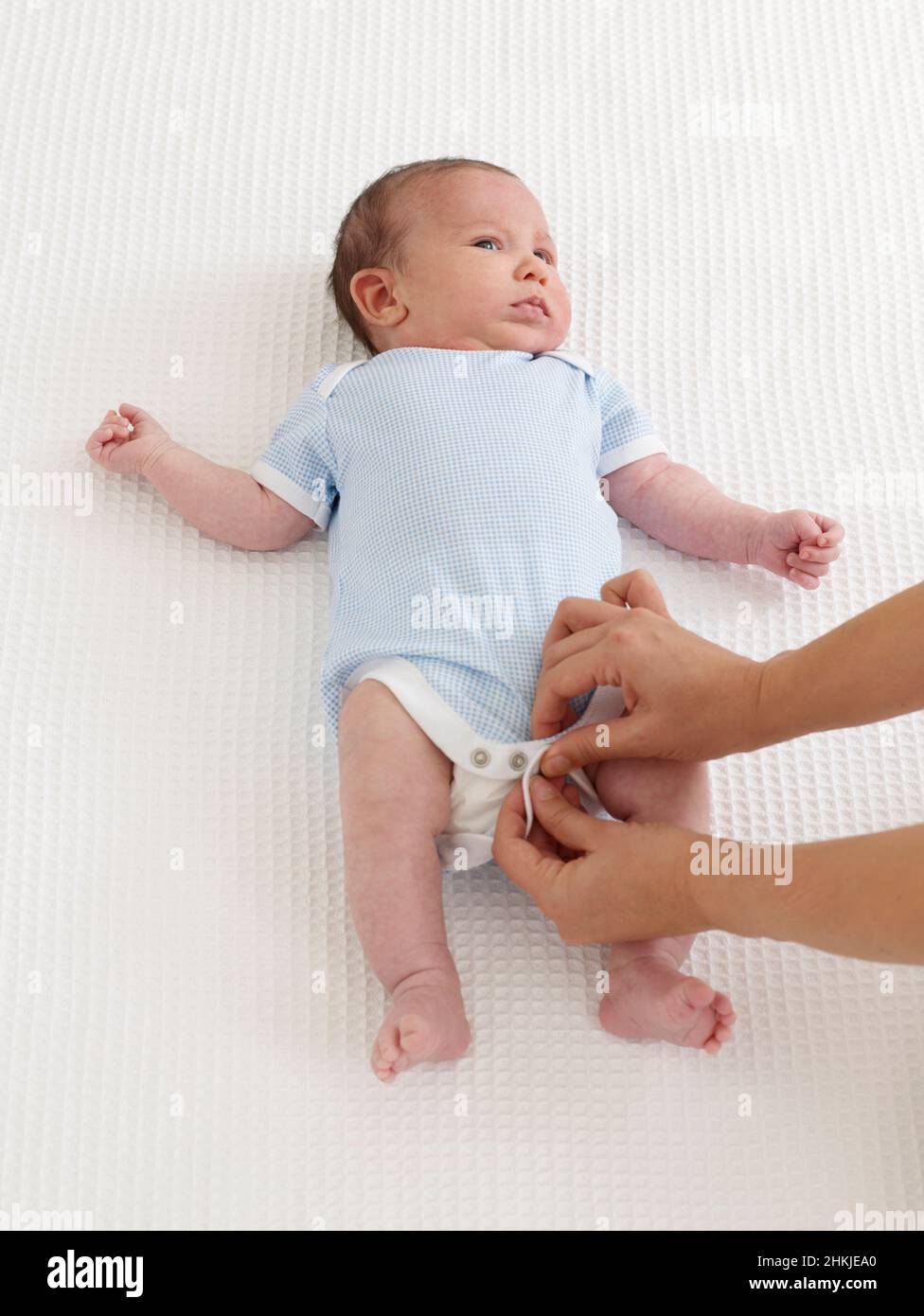 Buttoning the bottom of vest Stock Photo - Alamy