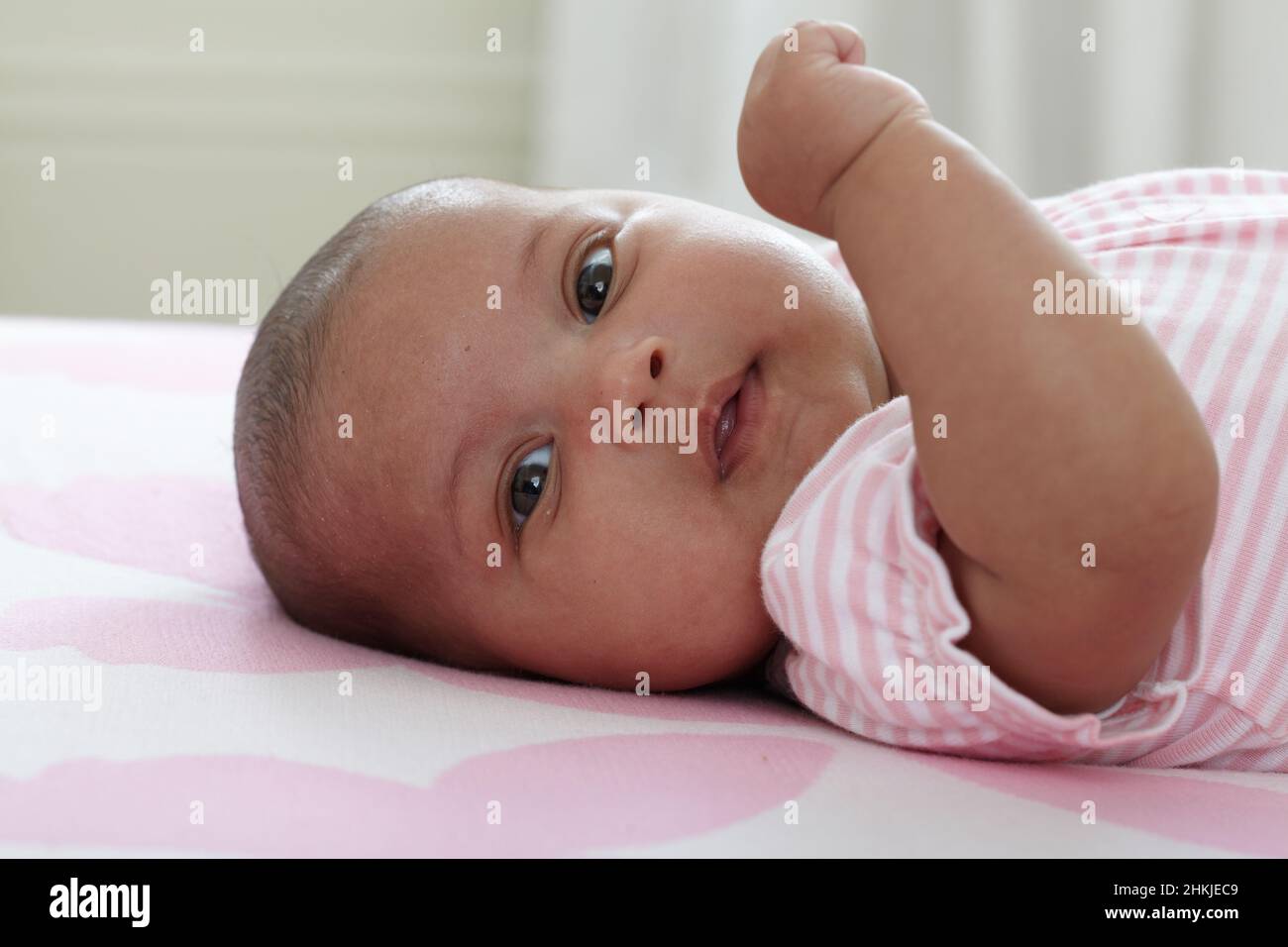 Baby girl lying on back Stock Photo - Alamy