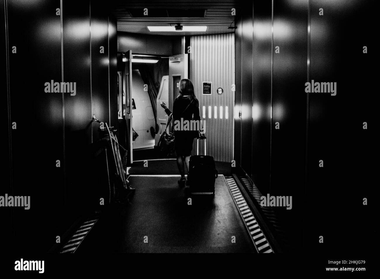 Woman in airport loading dock Stock Photo - Alamy