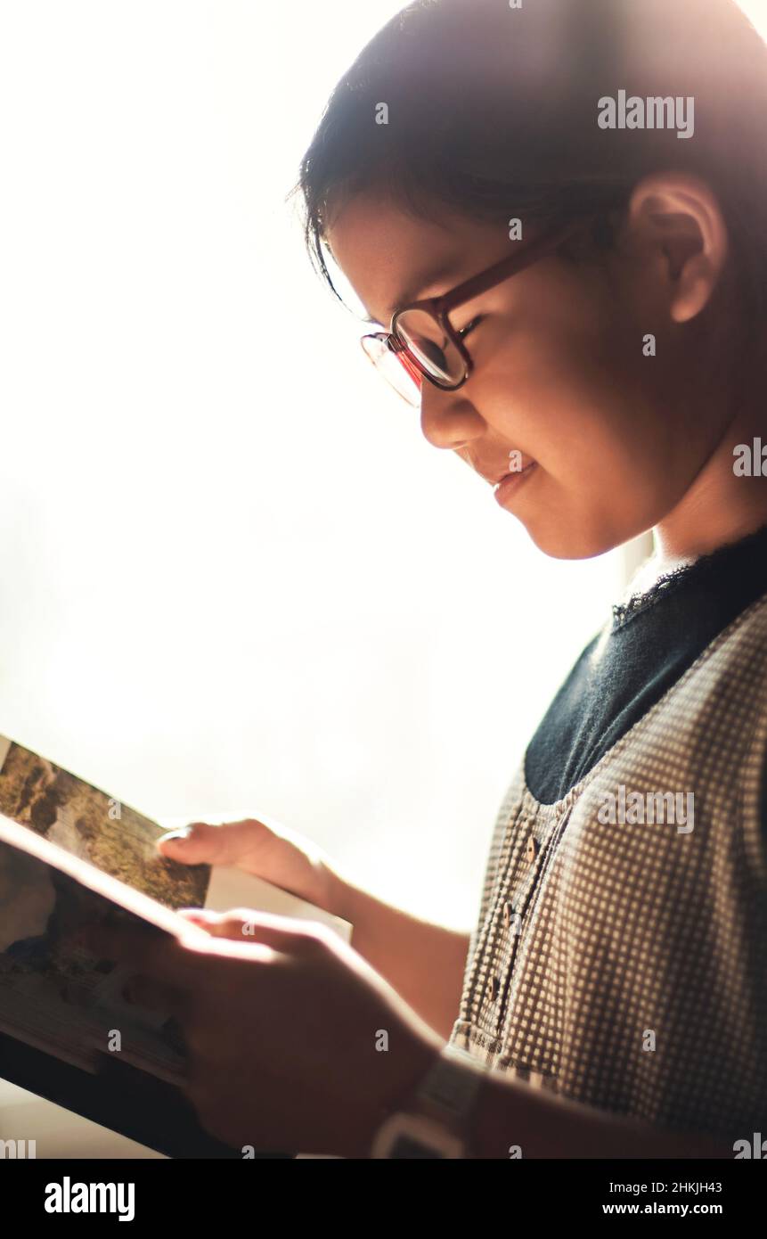 Portrait of a girl reading a book Stock Photo - Alamy