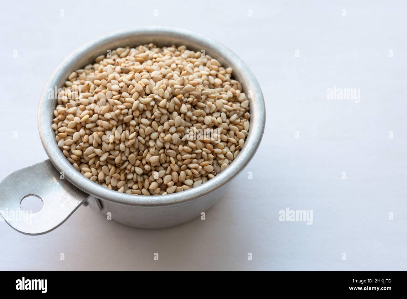 Toasted Sesame Seeds in a Measuring Cup Stock Photo - Alamy