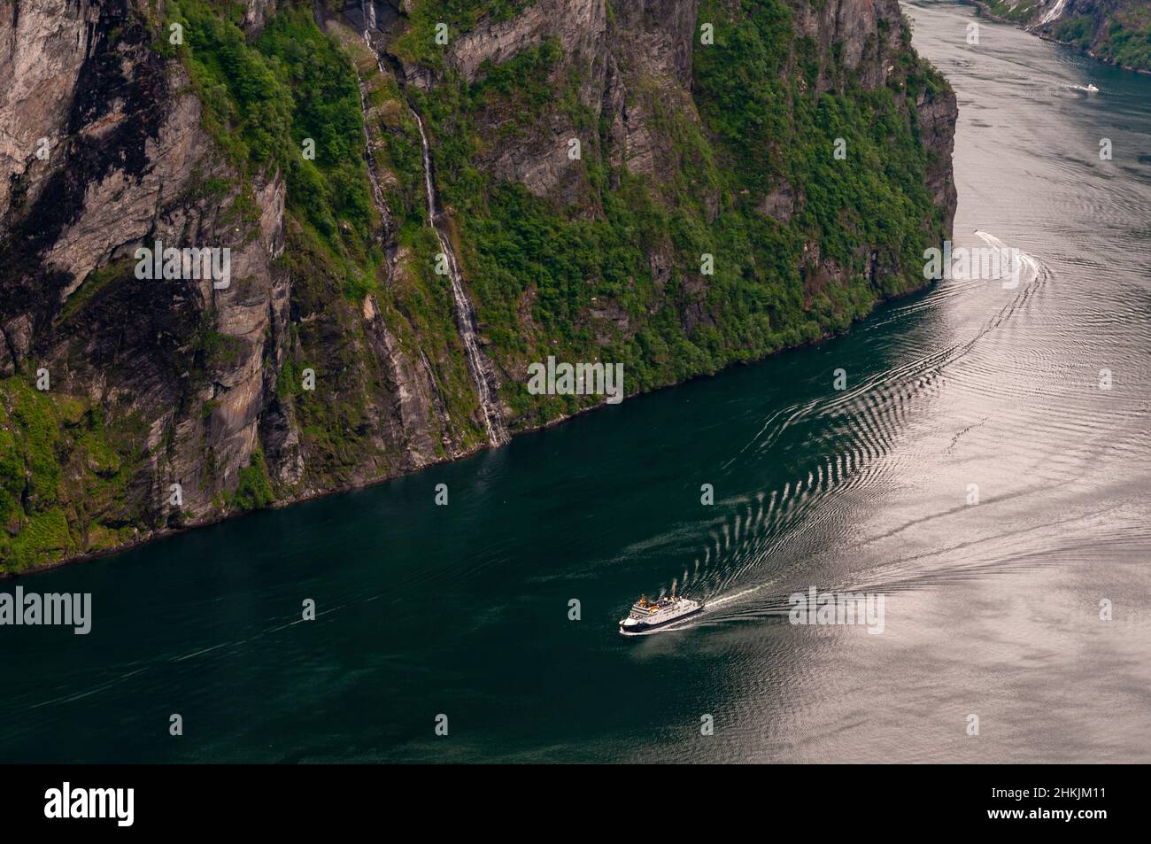 Cruise ship navigating past cliffs in Geirangerfjord, Norway Stock ...