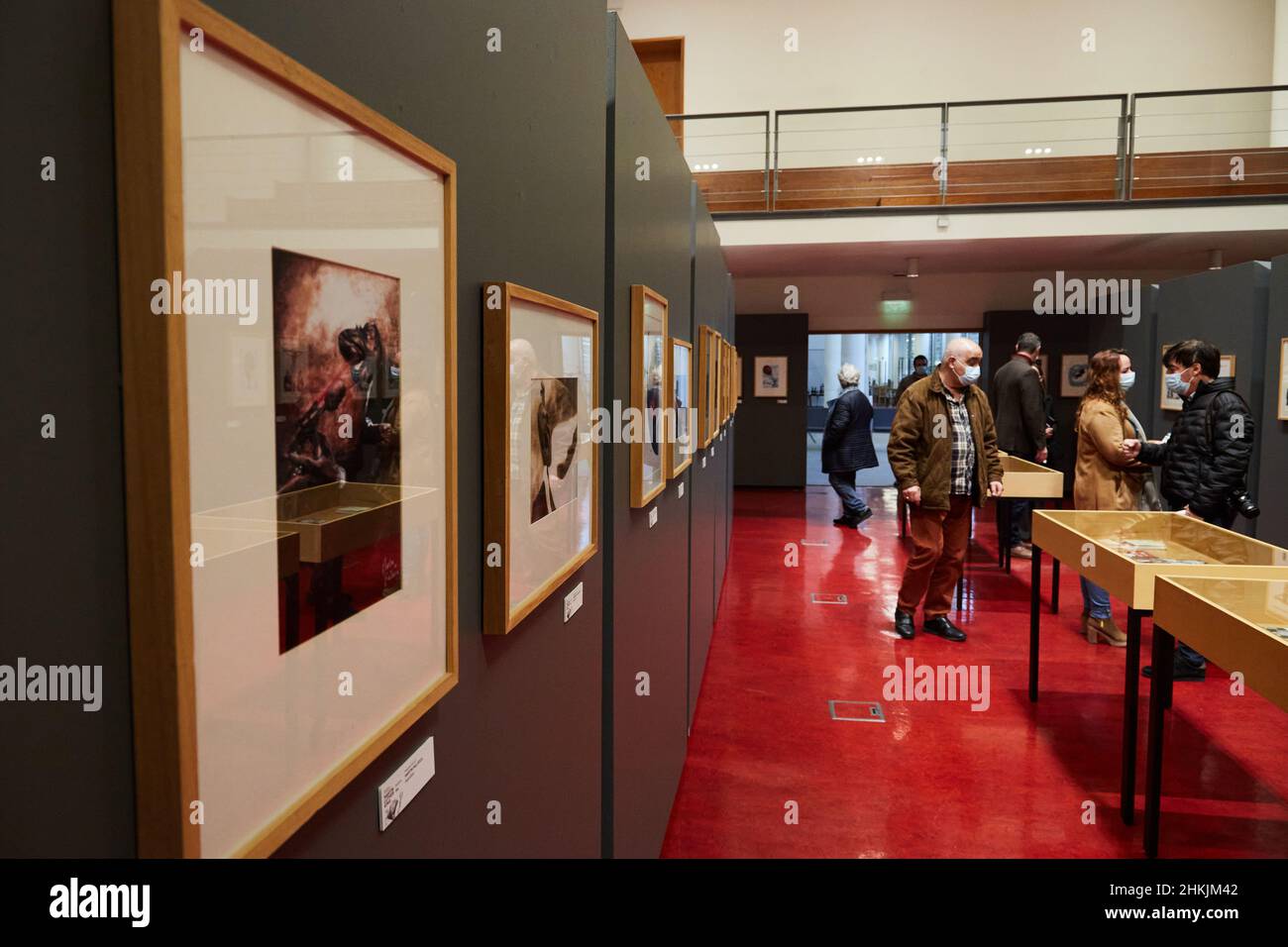 Visitors to the Caricature exhibition look at the artworks during the ...