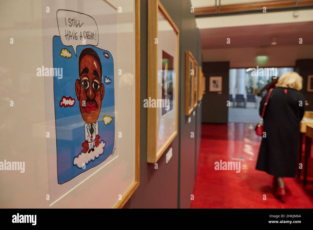 Visitor to the Caricature exhibition looks at the artworks during the ...