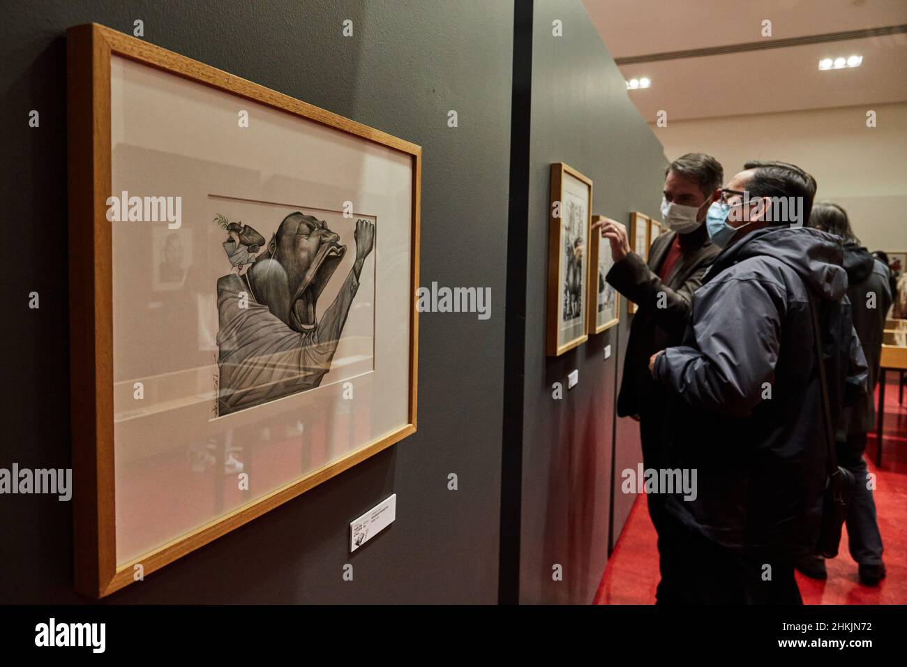 Visitors to the Caricature exhibition look at the artworks during the ...