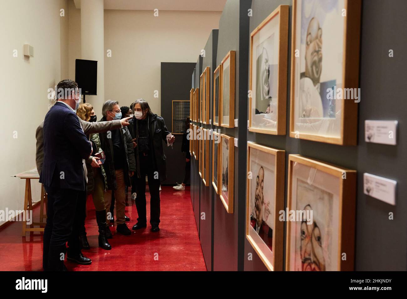 Visitors to the Caricature exhibition look at the artworks during the ...