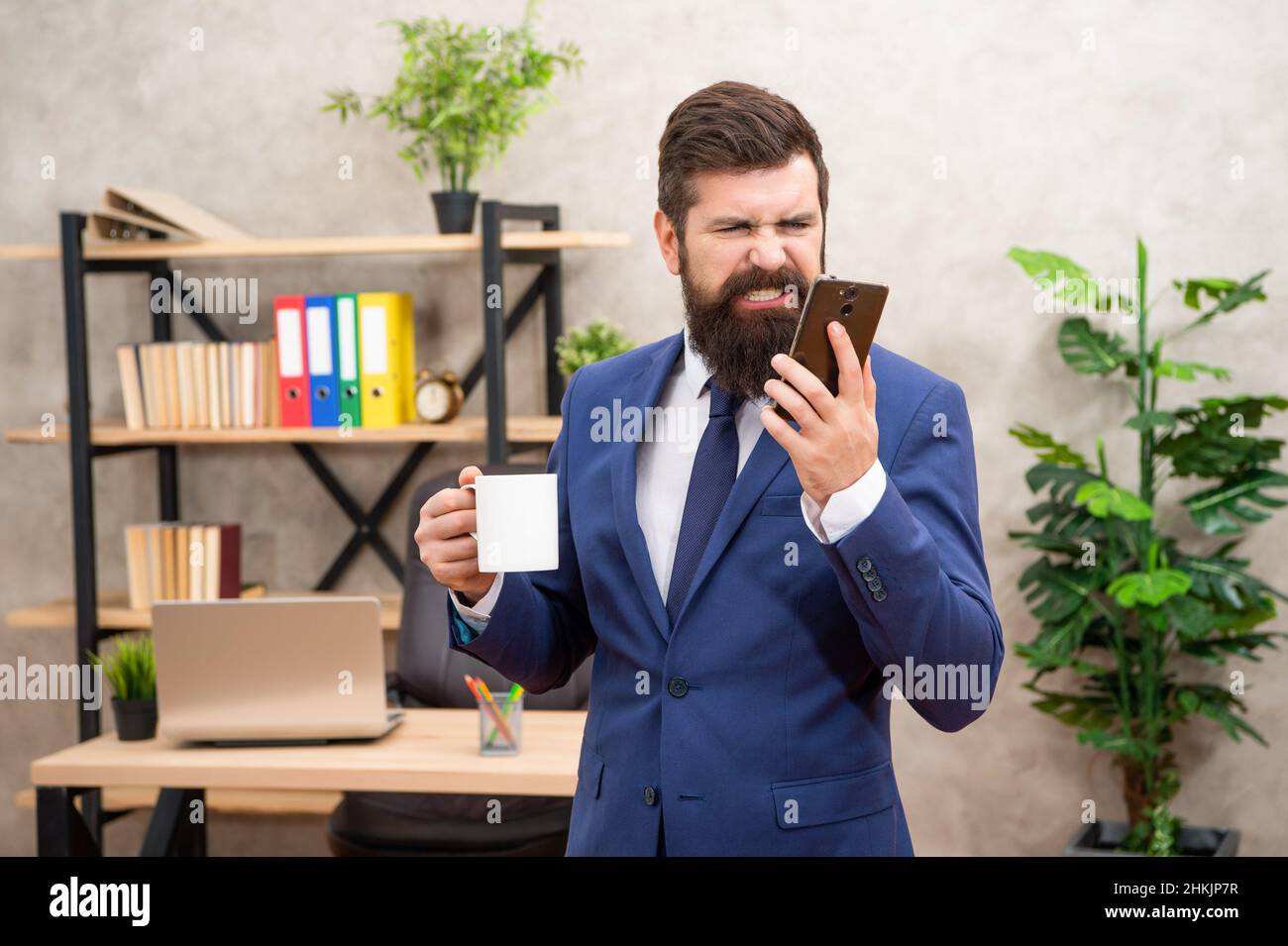 Stress at work. Angry man yelling at cellphone. Mobile communication ...