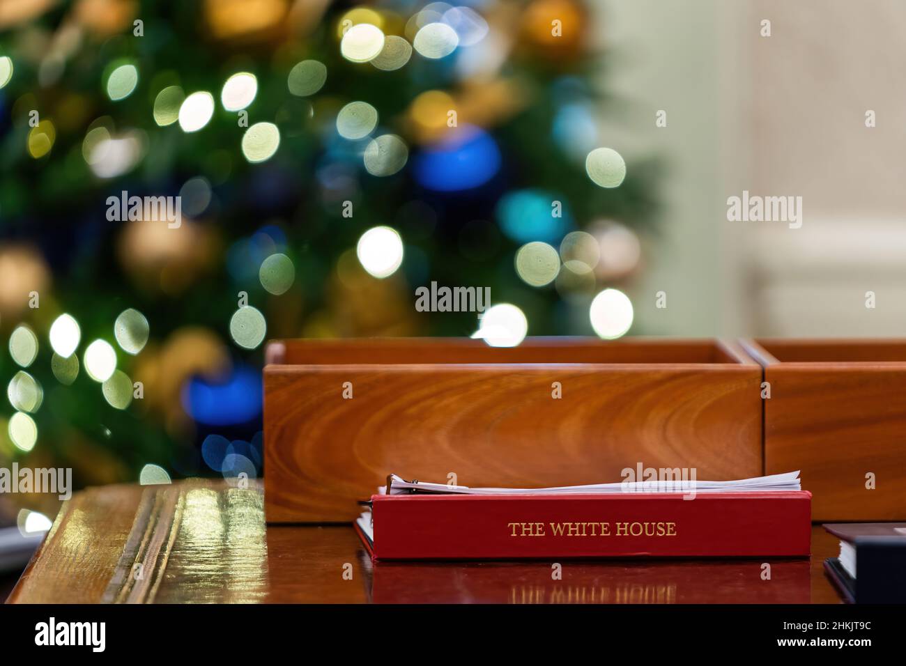 Binders sit on the Resolute desk as President Joe Biden works in the ...