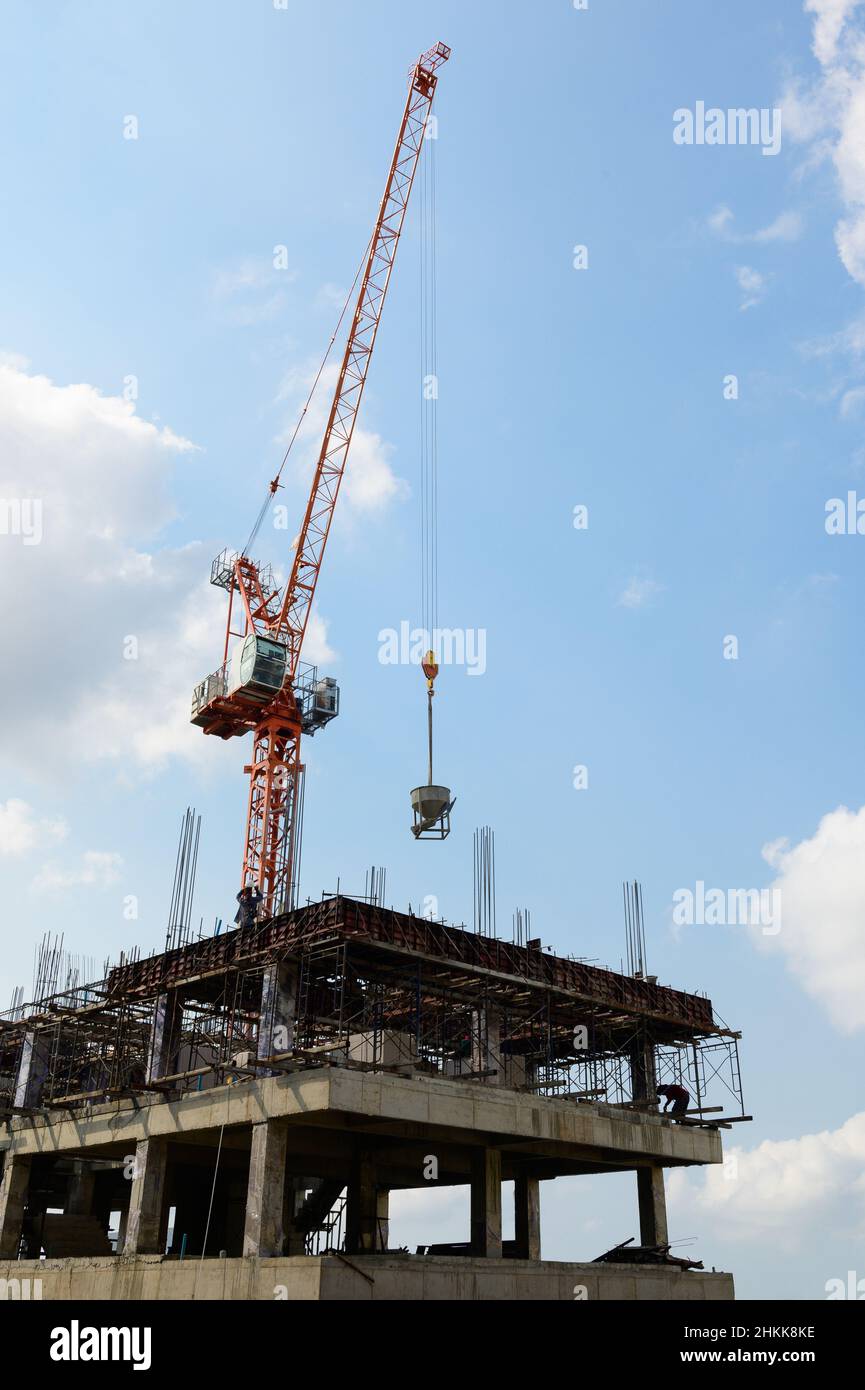 Crane lifting concrete container on construction site Stock Photo - Alamy