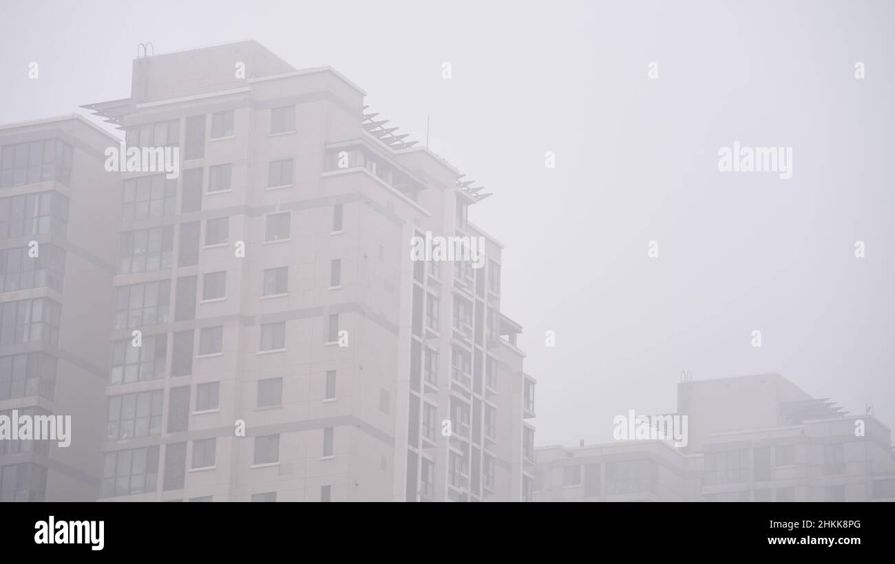 Beautiful view of buildings in a foggy weather Stock Photo - Alamy
