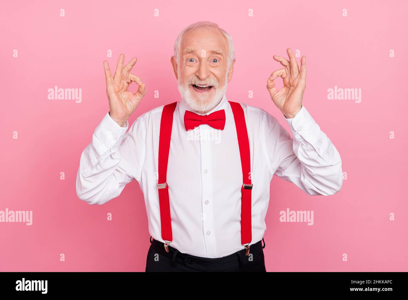 Portrait of attractive cheerful gray-haired guy showing double ok-sign ...