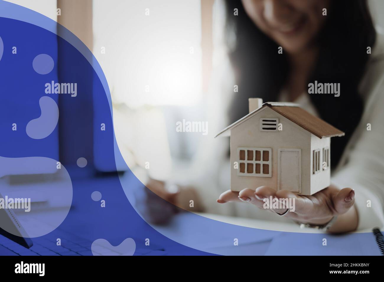 A woman holding and checking house model .Real Estate House Appraisal ...