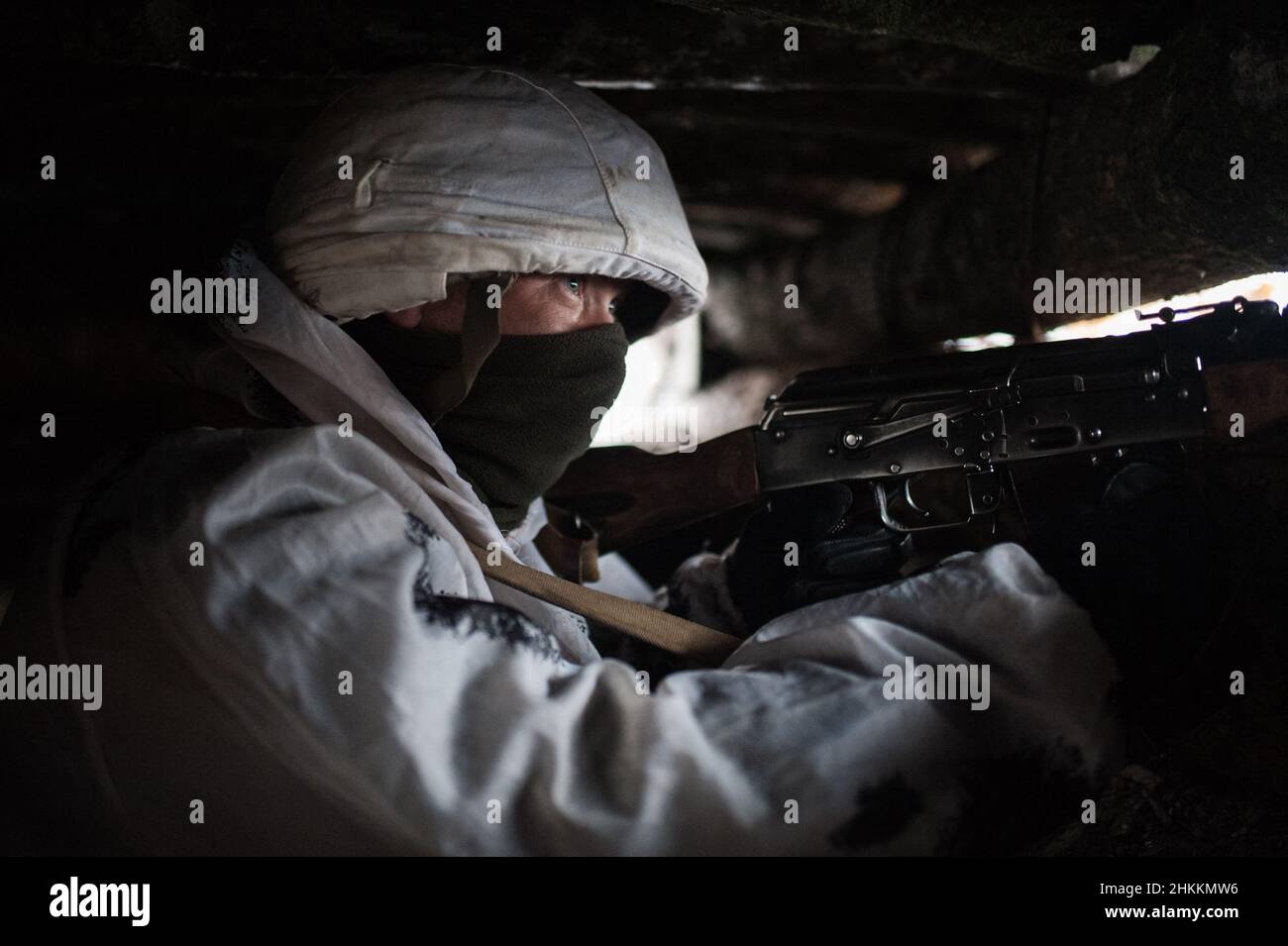 Pro-Russian Serviceman with a machine gun observing the front line in ...