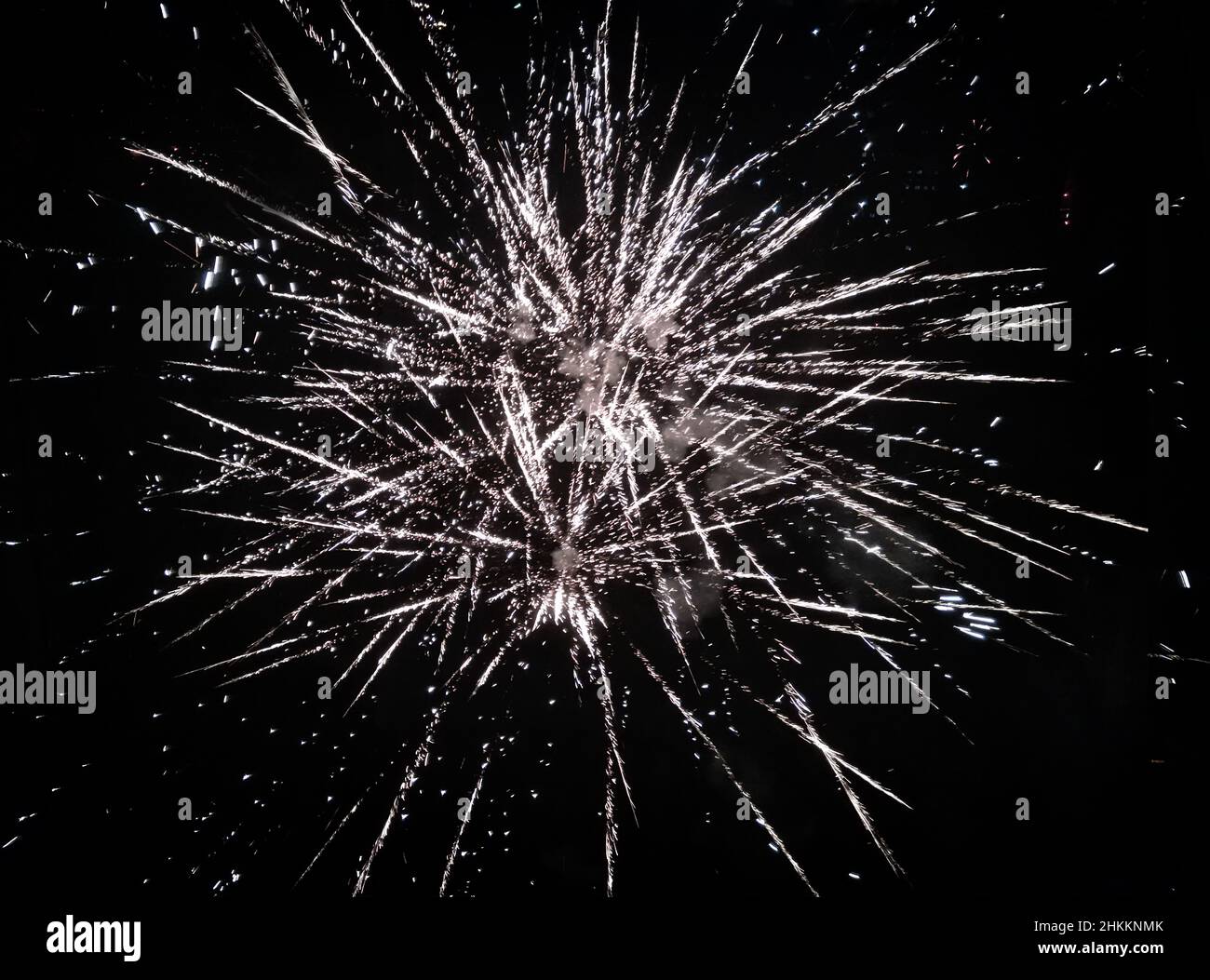 Dazzling firework exploding in the night sky Stock Photo - Alamy