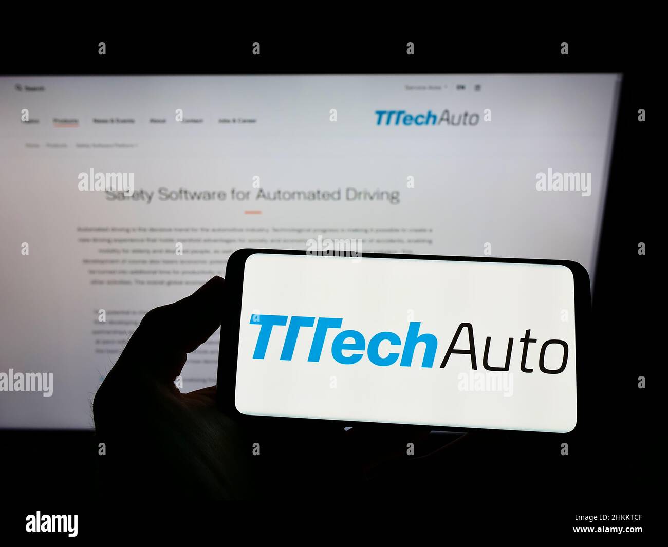 Person holding cellphone with logo of autonomous driving company TTTech ...