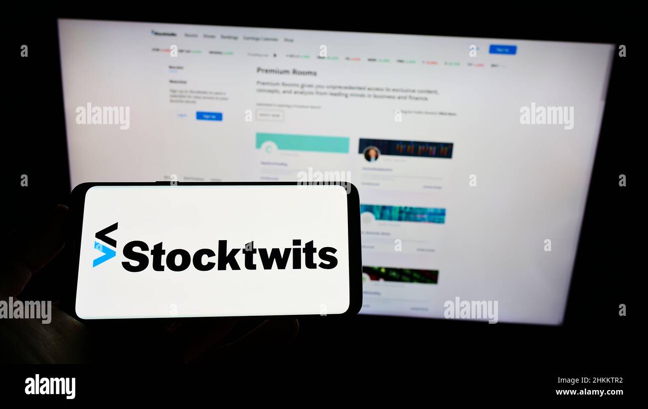 Person holding cellphone with logo of US social media company ...