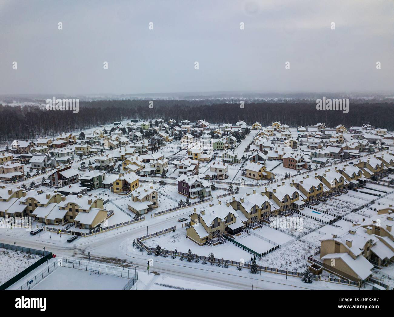 A row of identical houses in a suburban area near the city. Aerial view ...