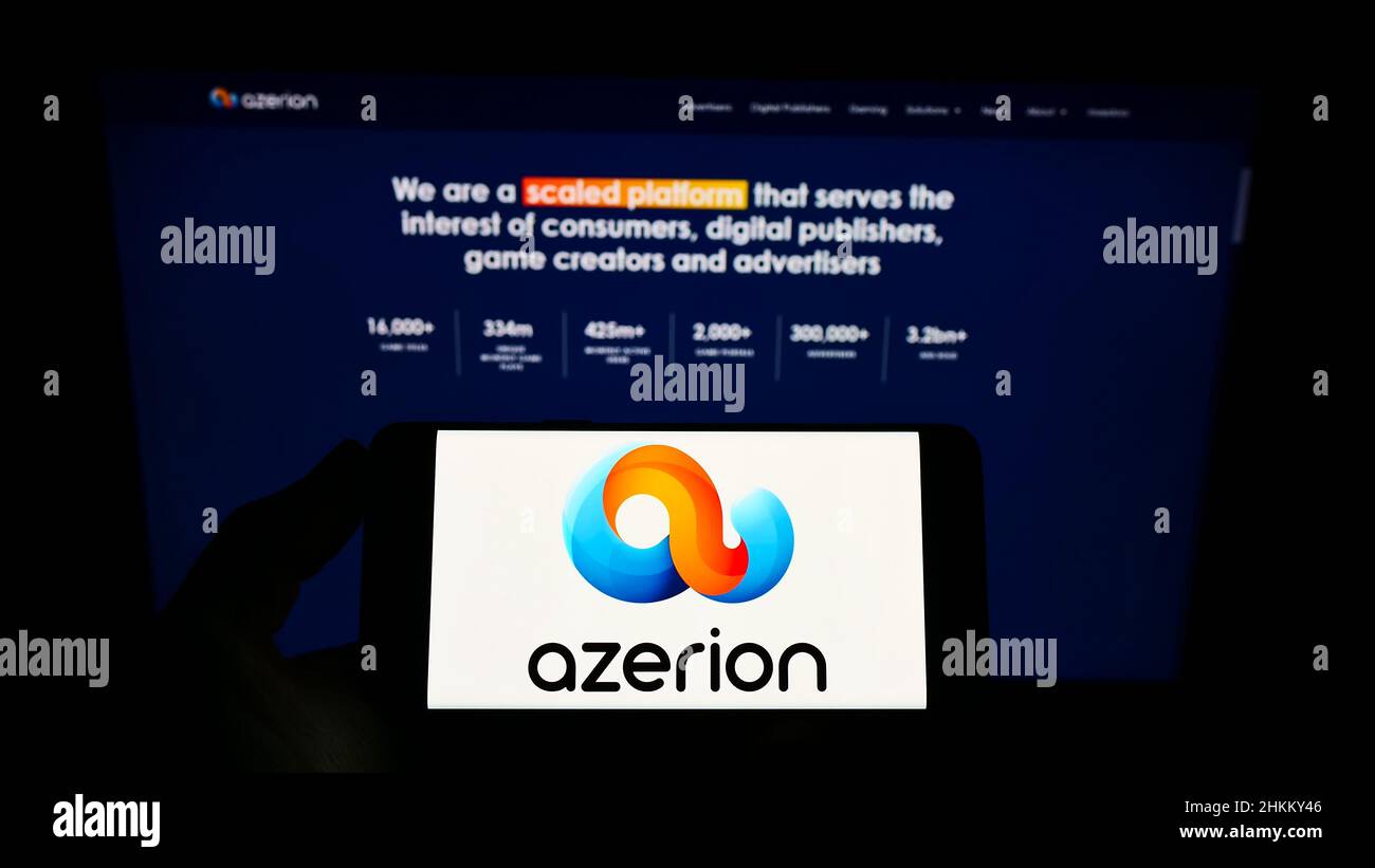 Person holding smartphone with logo of Dutch media platform company ...