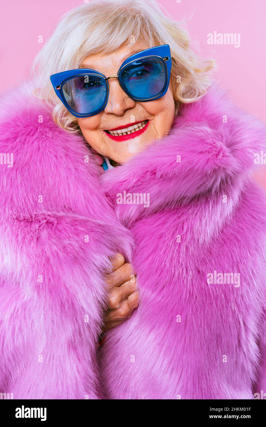 Happy and funny cool old lady with fashionable clothes portrait on ...