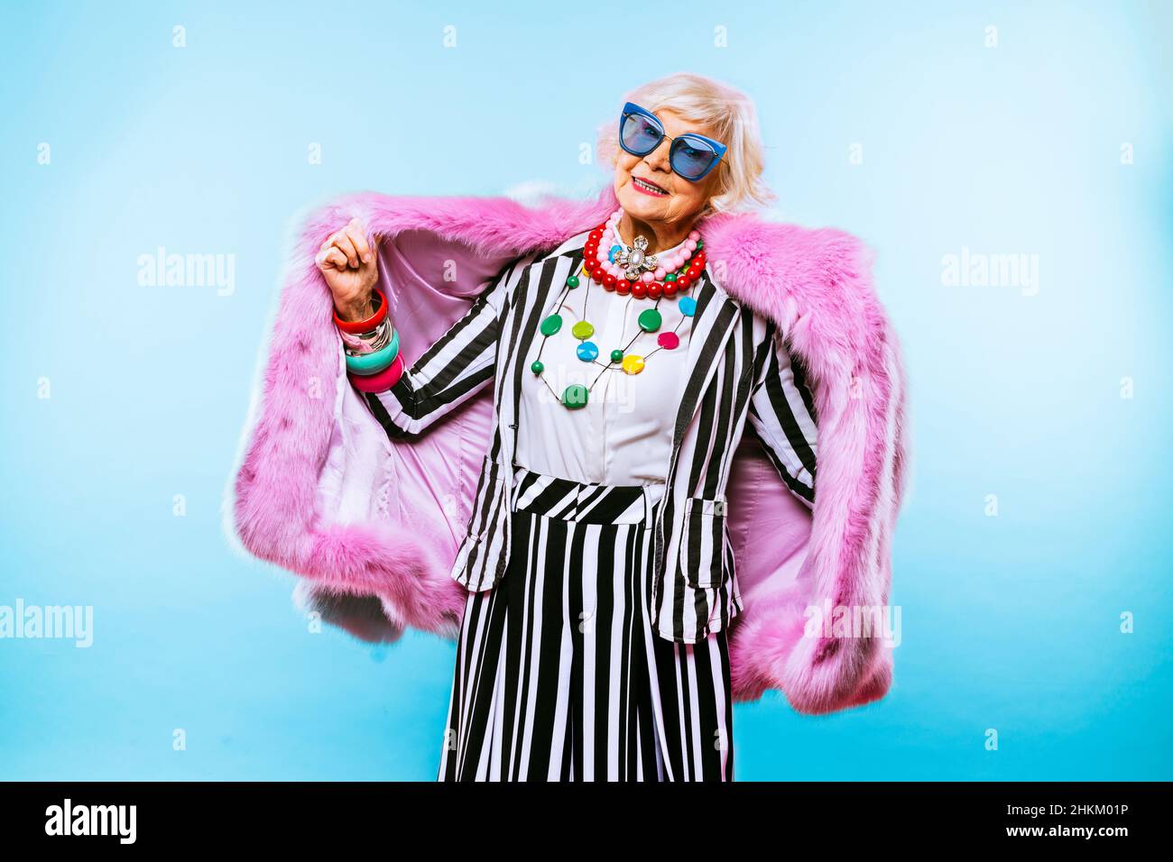 Happy and funny cool old lady with fashionable clothes portrait on ...