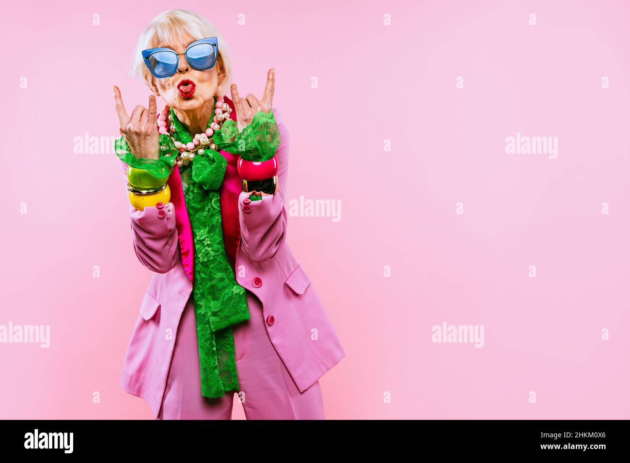 Happy and funny cool old lady with fashionable clothes portrait on ...