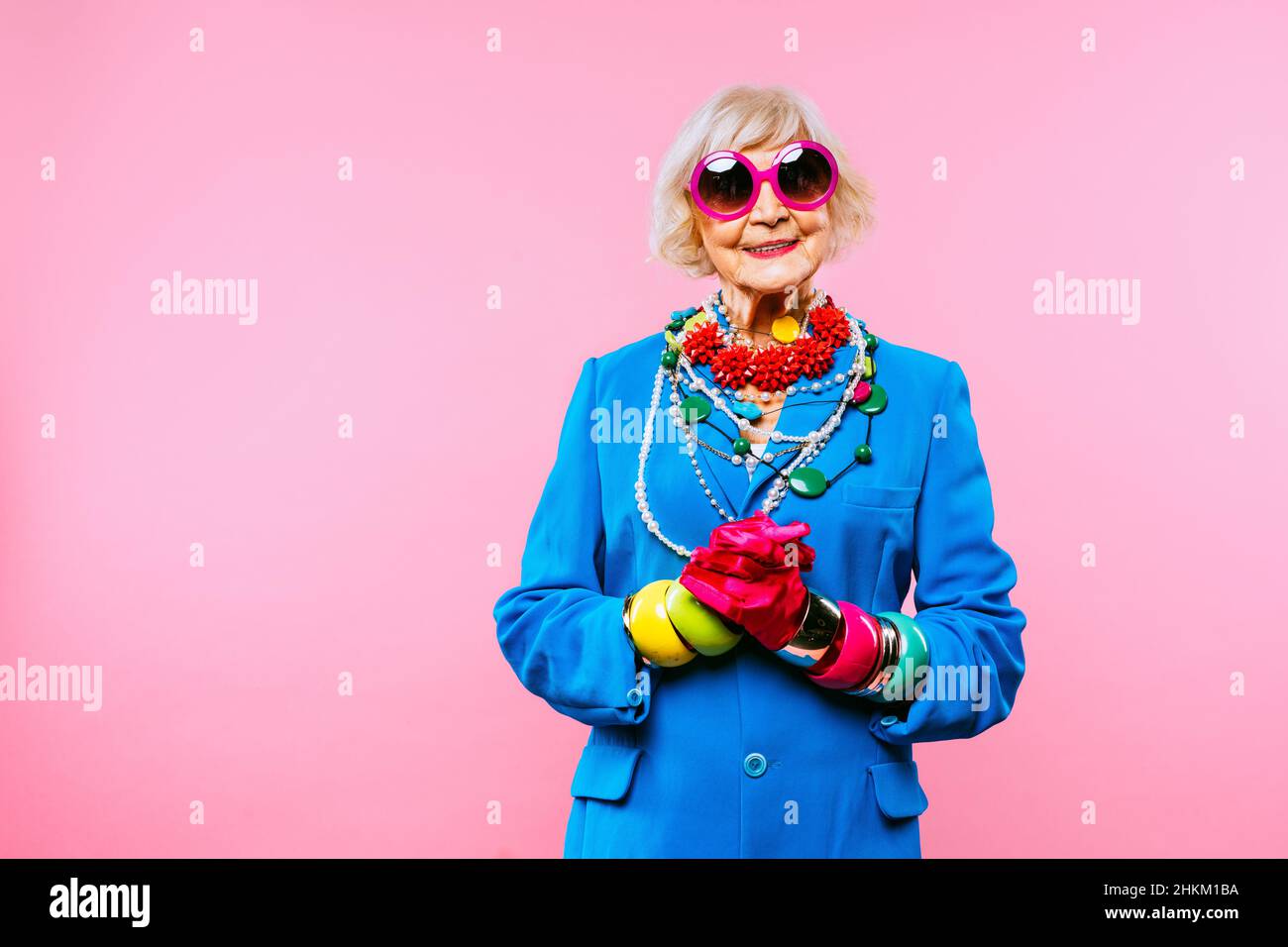 Happy and funny cool old lady with fashionable clothes portrait on ...